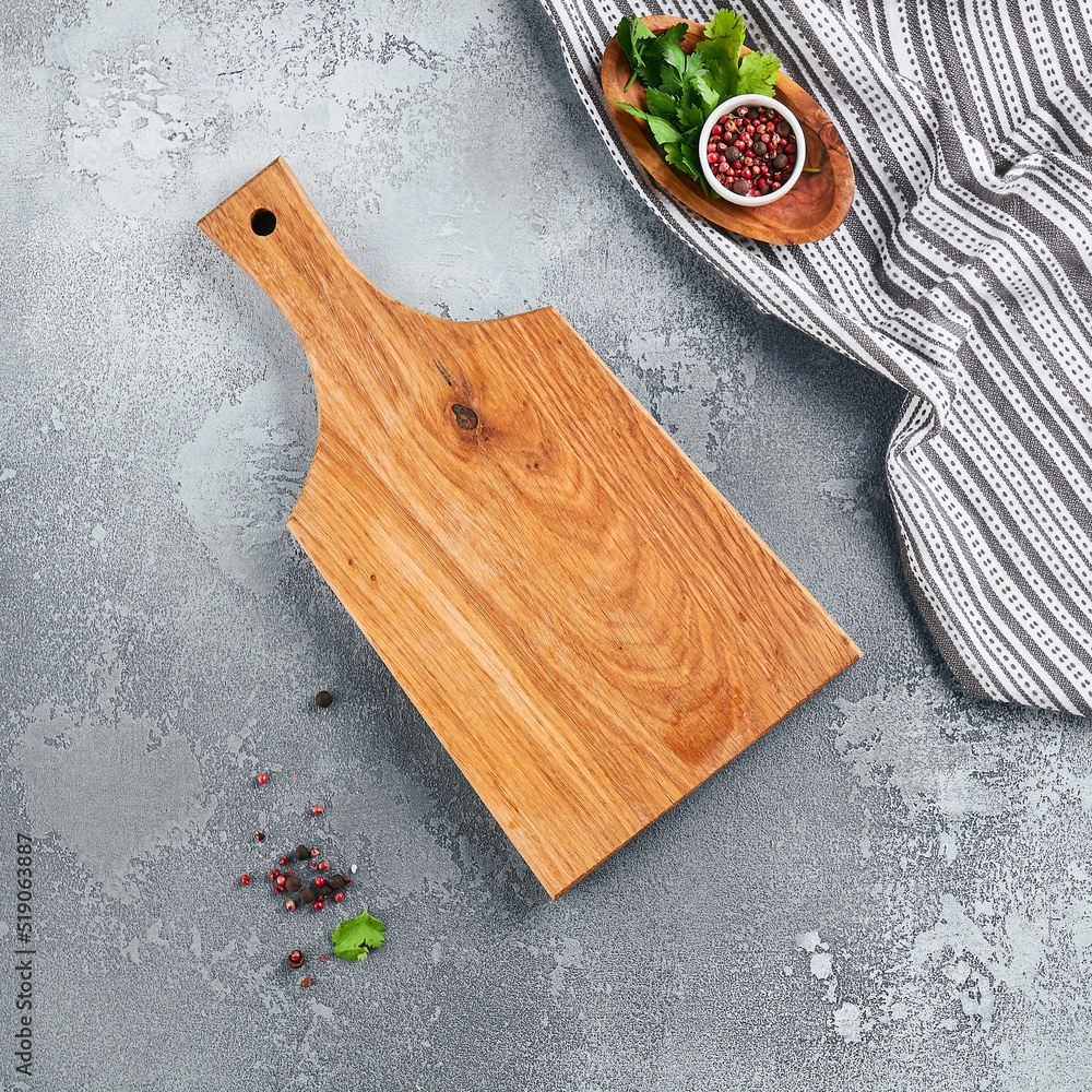 Food mockup. Empty wooden board on concrete table with cooking ...