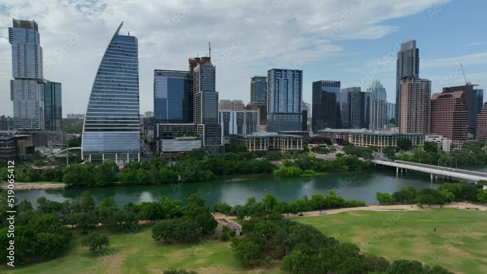 Rising aerial shot reveals green spaces, parks, Colorado River, and ...