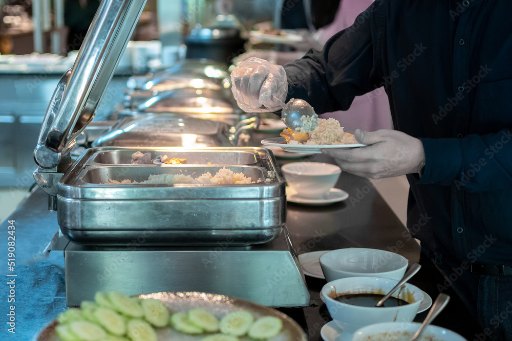 people grab food on buffet line on lunch break Stock Photo | Adobe Stock