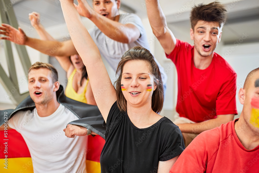 Happy fans with hands raised cheering together at stadium Stock Photo ...