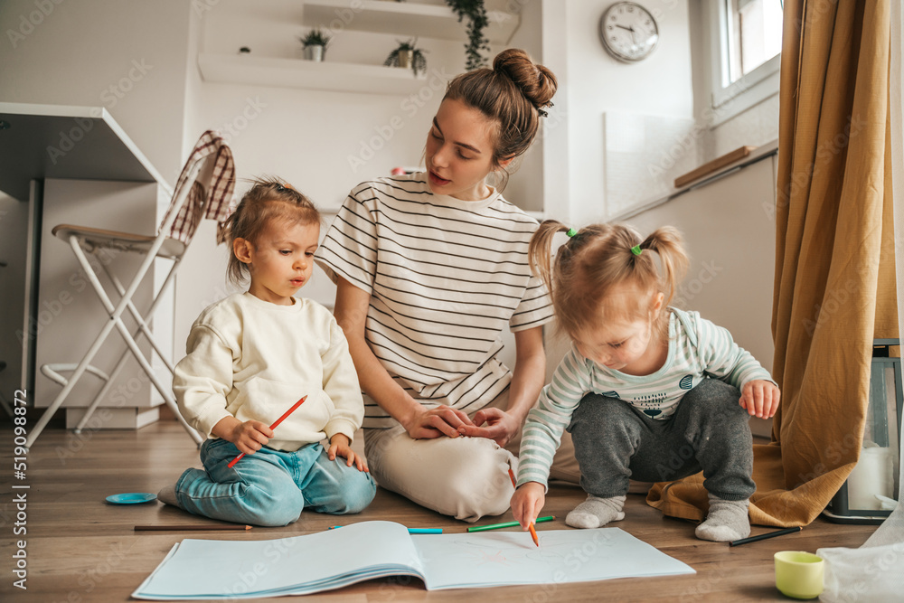 Young mother and her kids involved in a creative hobby Stock Photo ...