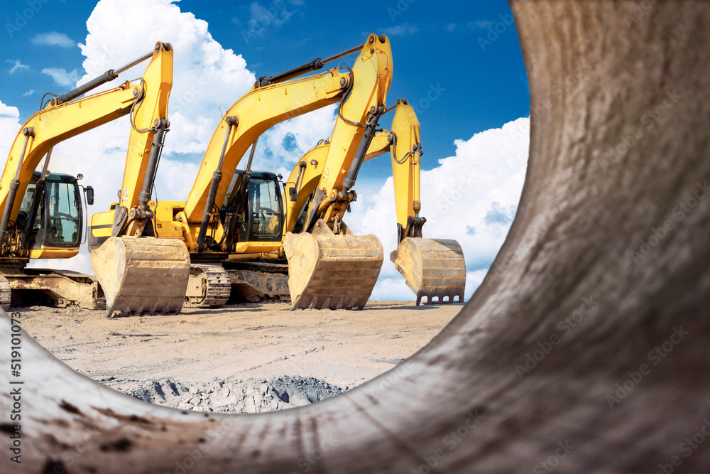 Foto de Powerful excavators at a construction site viewed from a large ...
