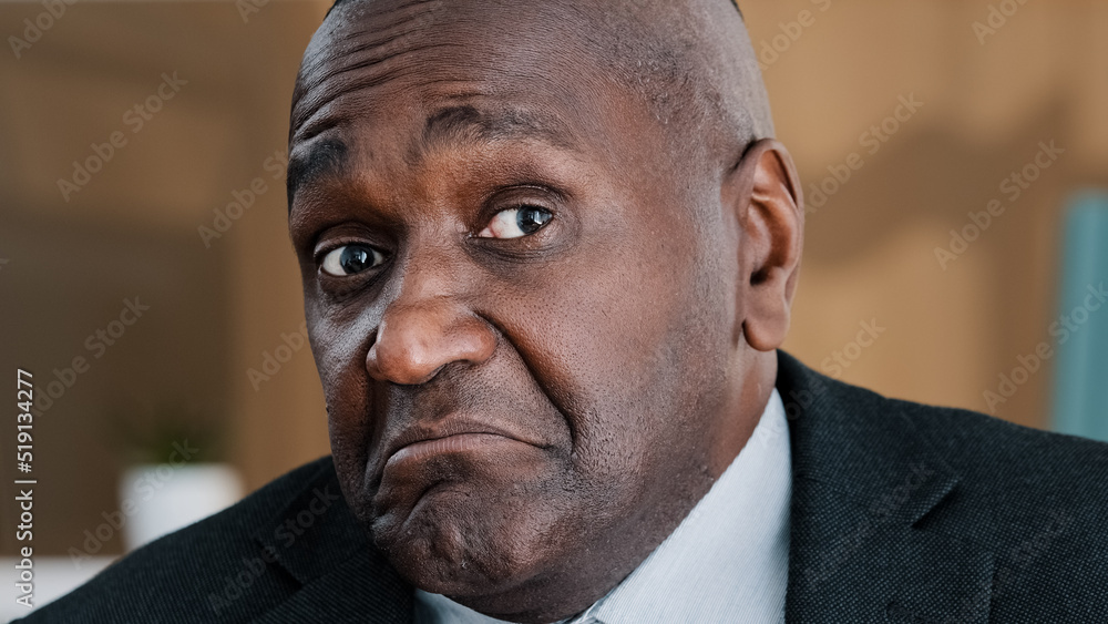 Extreme closeup old wrinkled emotional businessman African American ...