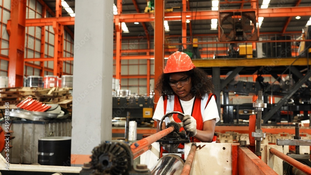 Engineer woman dark skin wearing orange uniform and safety orange ...