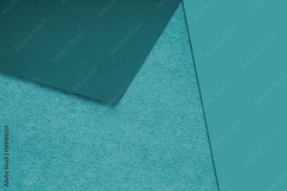 Plain and Textured pastel blue green papers randomly laying to form M ...