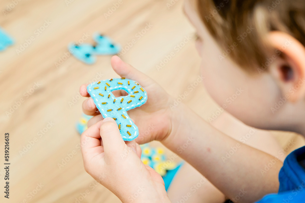 Full of sensory alphabet in capital letters made from stuffed felt. Toy ...