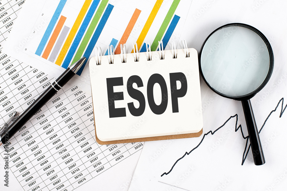 ESOP text on notebook on the graph background with pen and magnifier ...