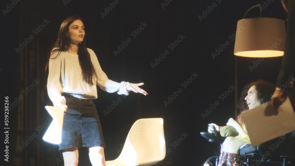 Theater actors with a disabled actress in a wheelchair with scripts ...