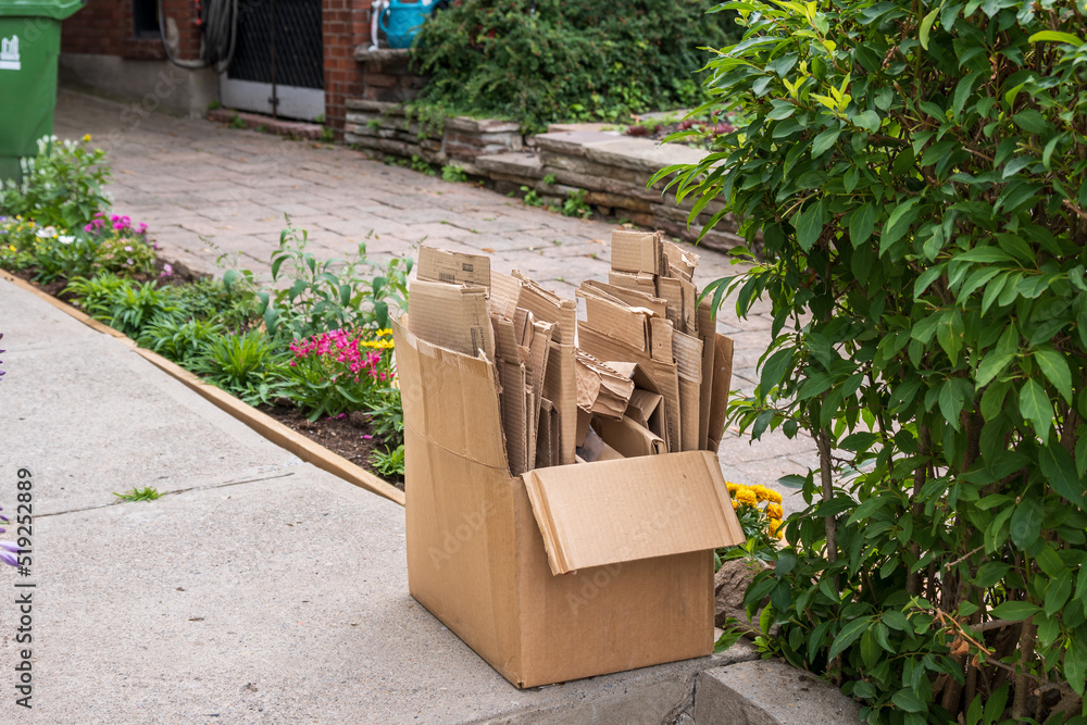 Boxed up used cardboard put out on the curb for pick up on a ...