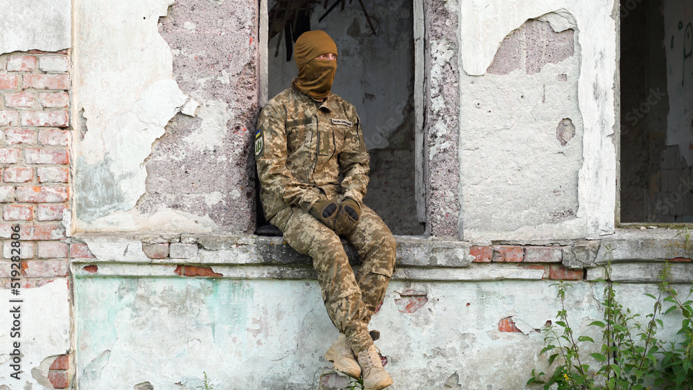 Ukrainian soldier in camouflage uniform and balaclava with "Ukrainian ...