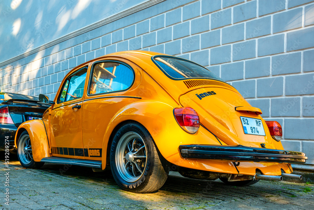 Classic bright orange Volkswagen Type 1 Beetle back low point of view ...