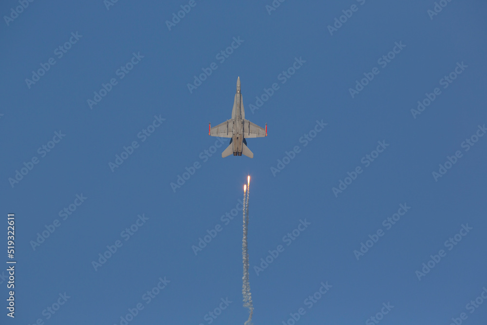 Warfare concept image. Modern jet fighter doing manuevers on a sunny ...
