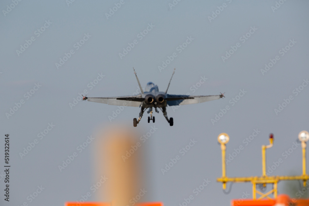 Warfare concept image. Modern jet fighter landing behind the runway ...