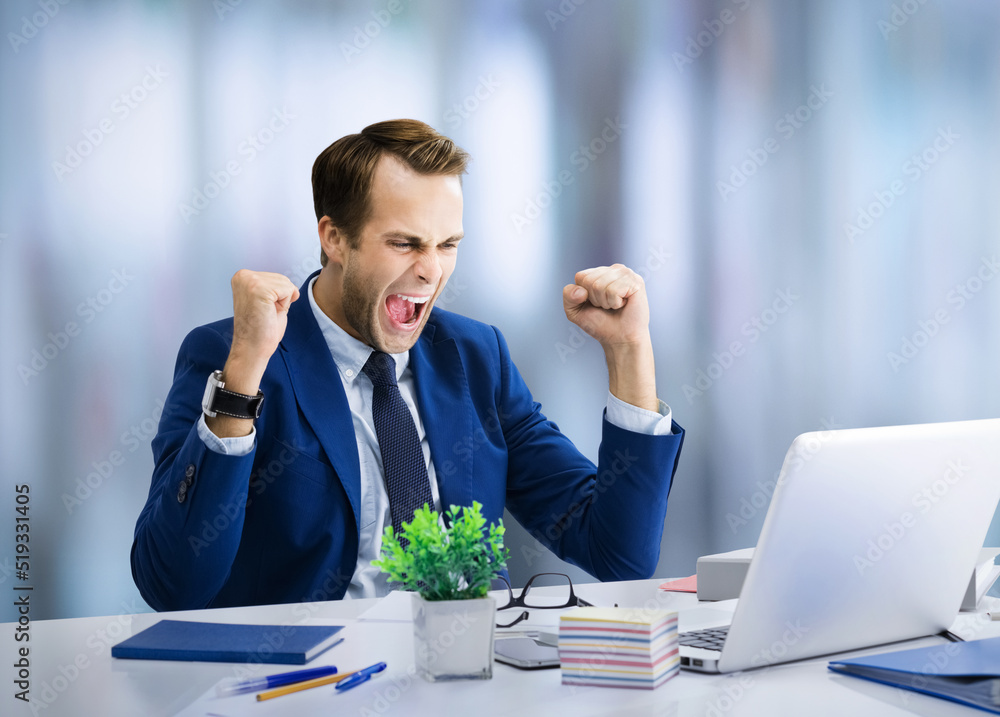 Very happy business man in confident suit, working with laptop at ...
