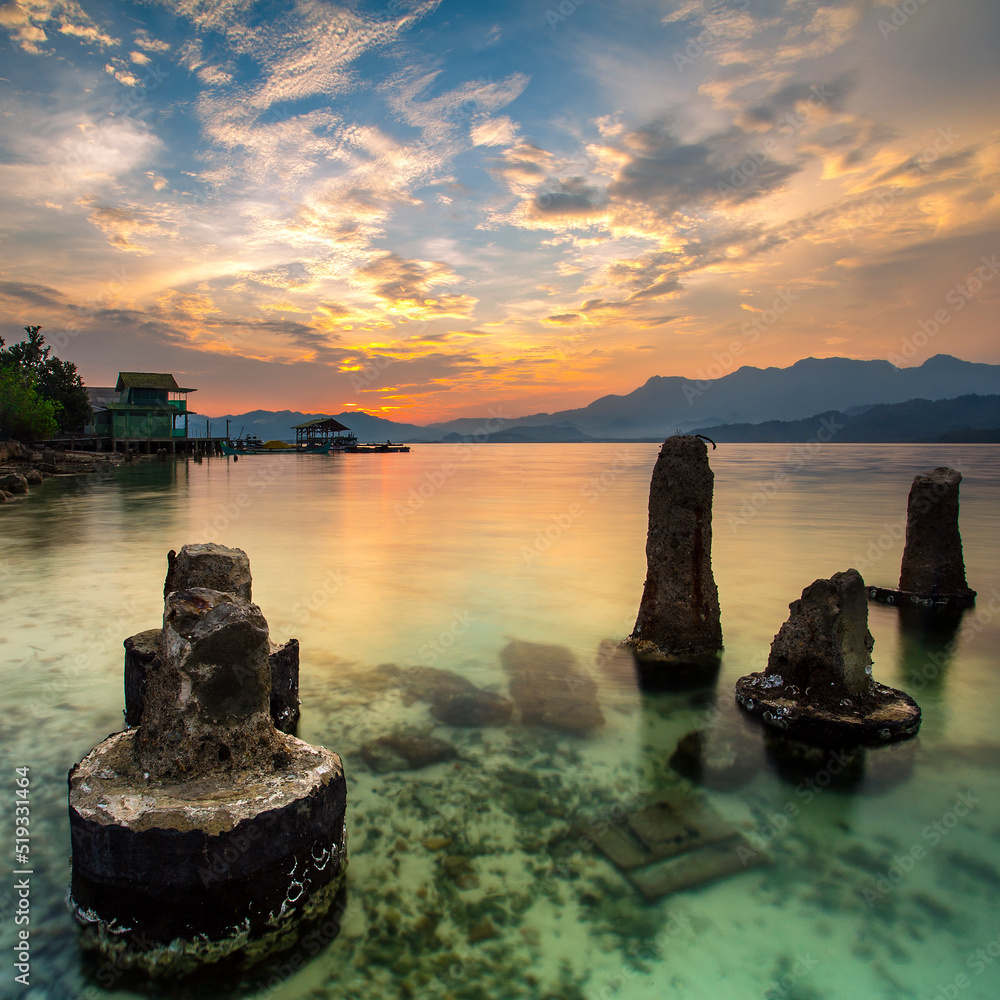 stunning sunset on the beach Tanjung Putus Lampung. building on a clear ...