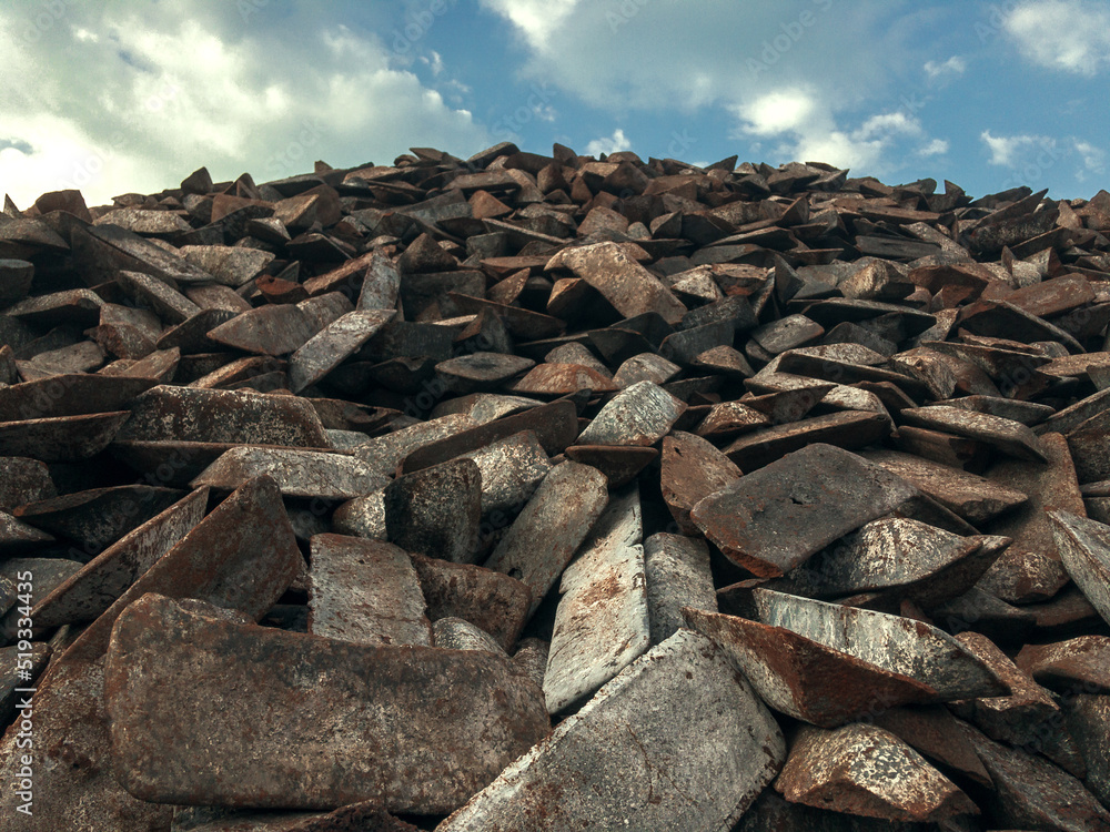 Cast-iron piglets in a warehouse against a blue sky. The form of cast ...