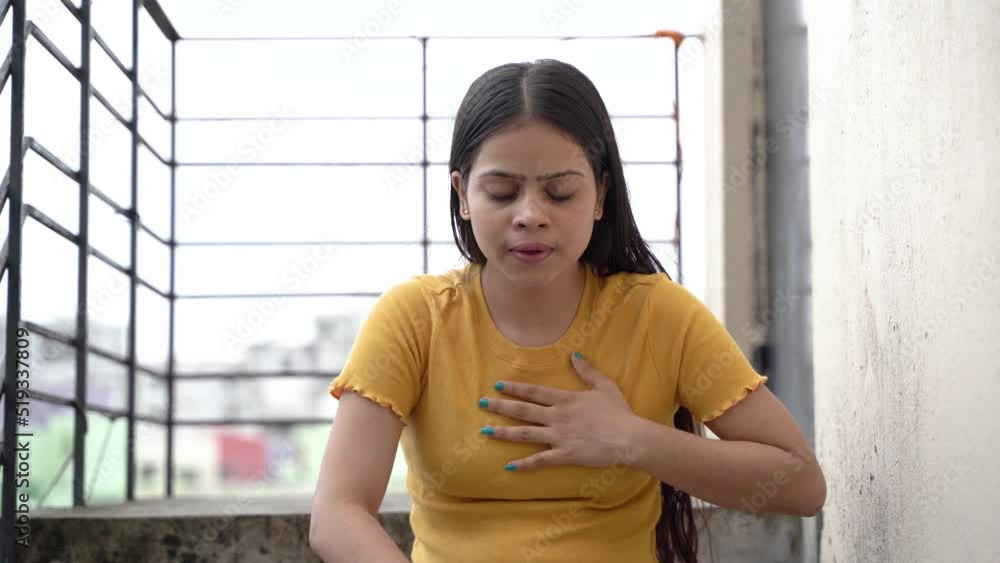 Asthmatic patient catching inhaler having an asthma attack. Young woman ...
