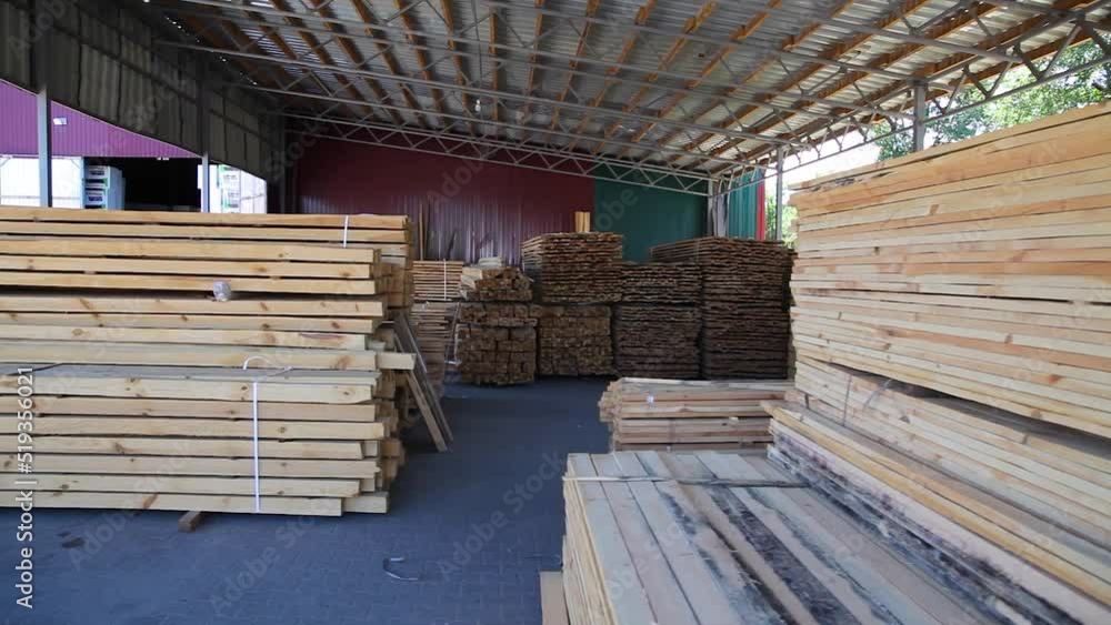 Wood warehouse. Sliced wooden boards are stored in a trading warehouse ...