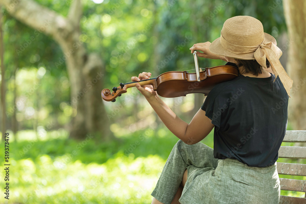 Beautiful asian woman hold violin on nature background, in emotion ...