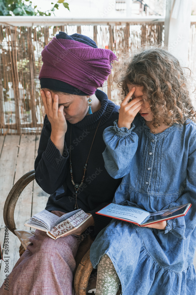 Young religious jewish woman with a headscarf on her head prays with ...
