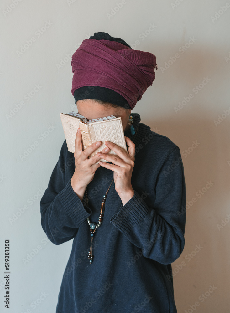 Young jewish religious woman praying with siddur in her hands (62 ...