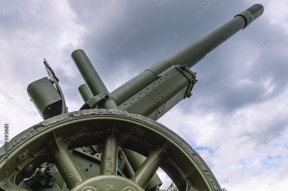 The barrel of a large-caliber howitzer with a muzzle brake. A weapon ...