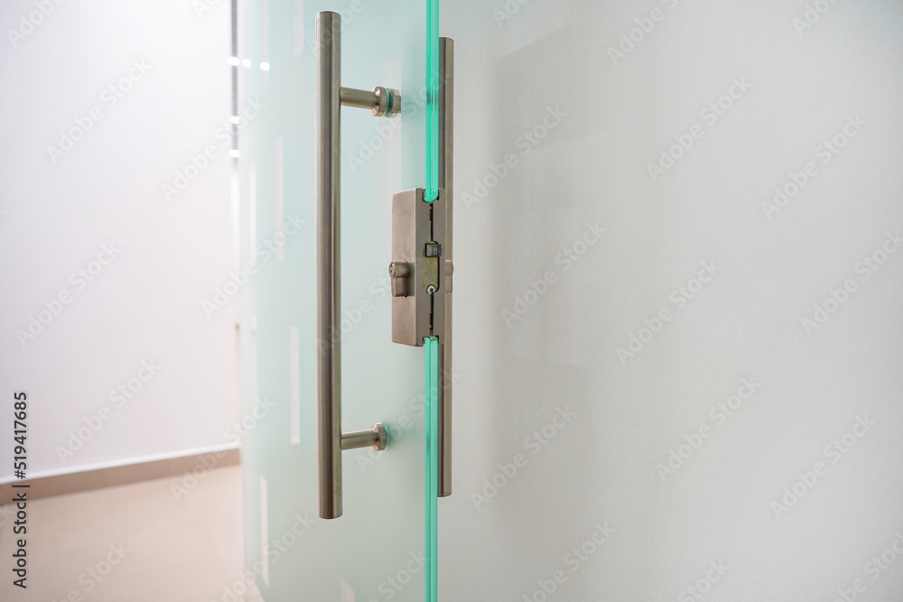 Closeup view of open the office glass door. Close-up glass door to ...