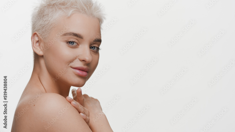 Blond beautiful slim young Caucasian half-turned woman with hands on ...