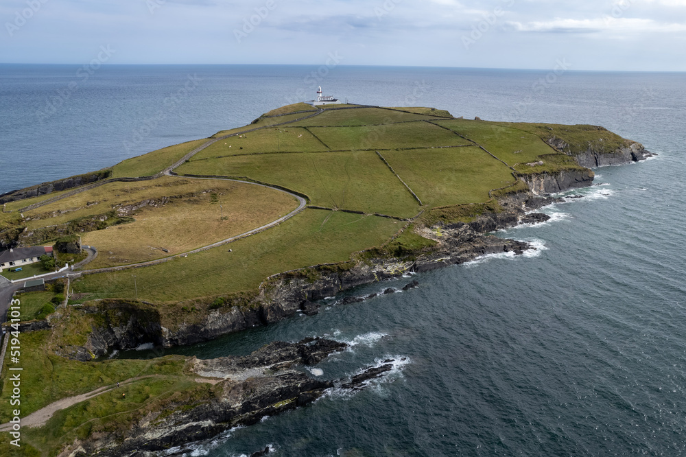 Drone aerial scenery of galley head with lighthouse and green field in ...