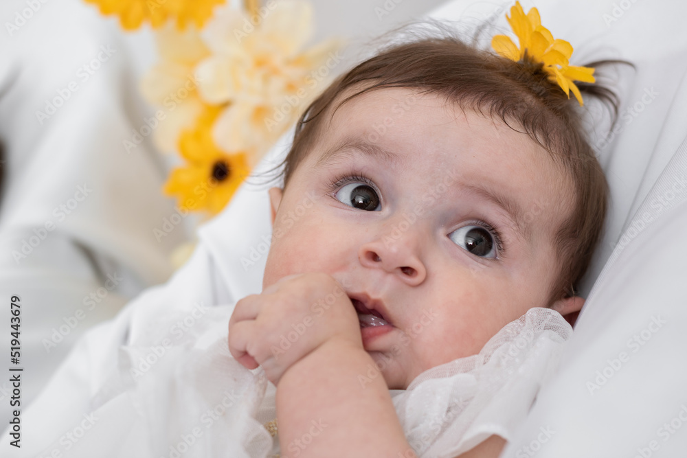 detailed view of a beautiful baby lying in her crib, with her gaze ...