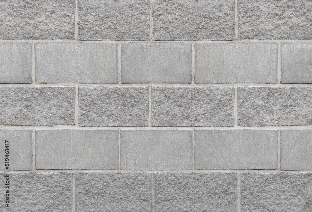 Grey wall made of rectangular concrete blocks of different structures ...
