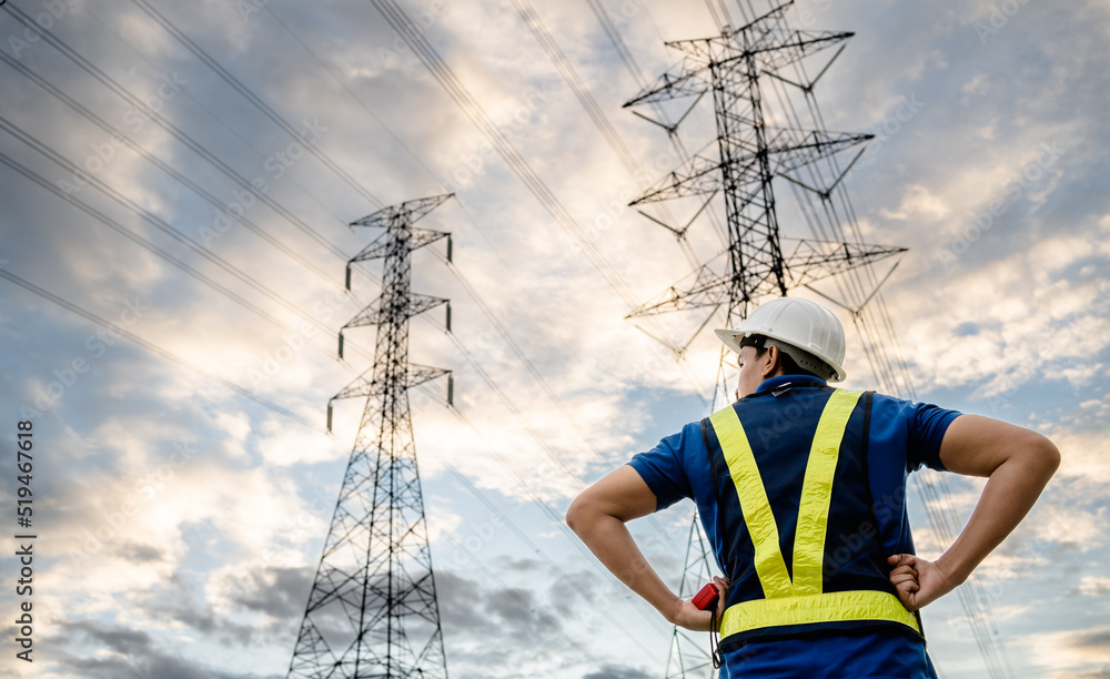 Rear of view Electrical engineers standing using a walky talky and ...