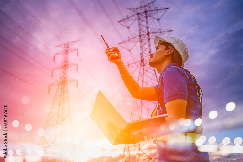 Side of view Electrical engineers standing holding a walky talky and ...