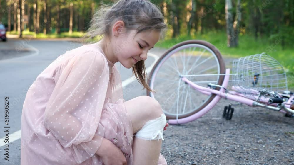 Teen girl grimaces because of pain in leg. Girl wearing pink dress ...
