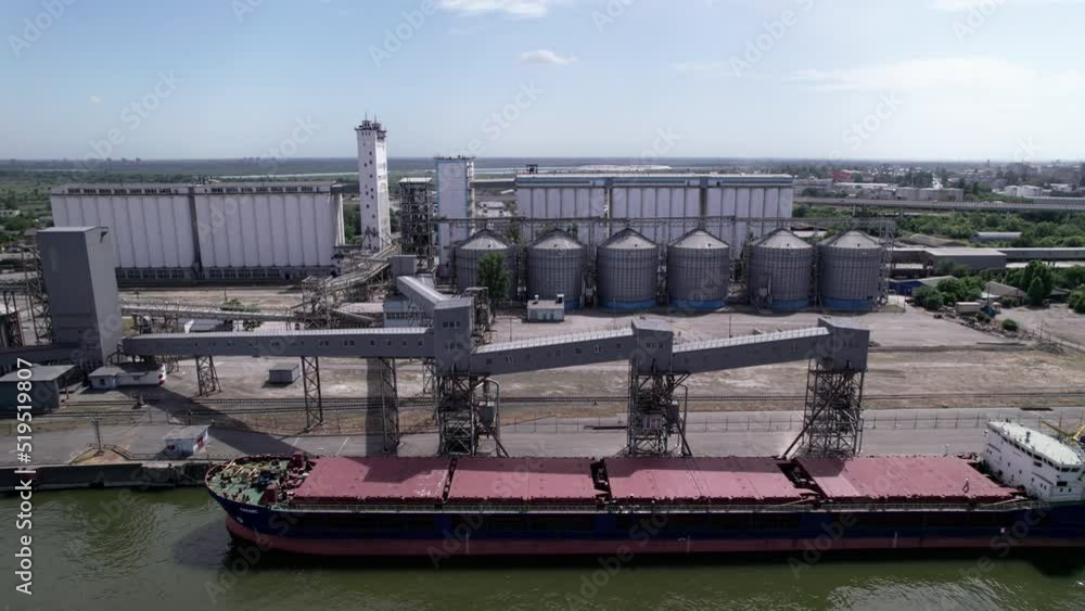 Bulk carrier ship in cargo port. Aerial view of barge in a dock. Grain ...
