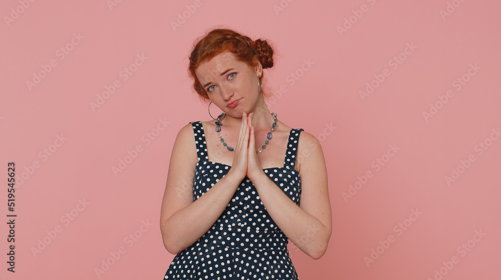 Please, God help. Young redhead woman praying, looking upward and ...