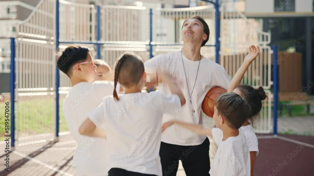 Basketball team unity. Front view of young european basketball coach ...