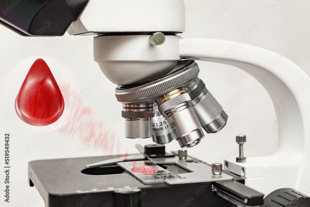 Close-up microscope and glass with a drop of blood for diagnosis ...