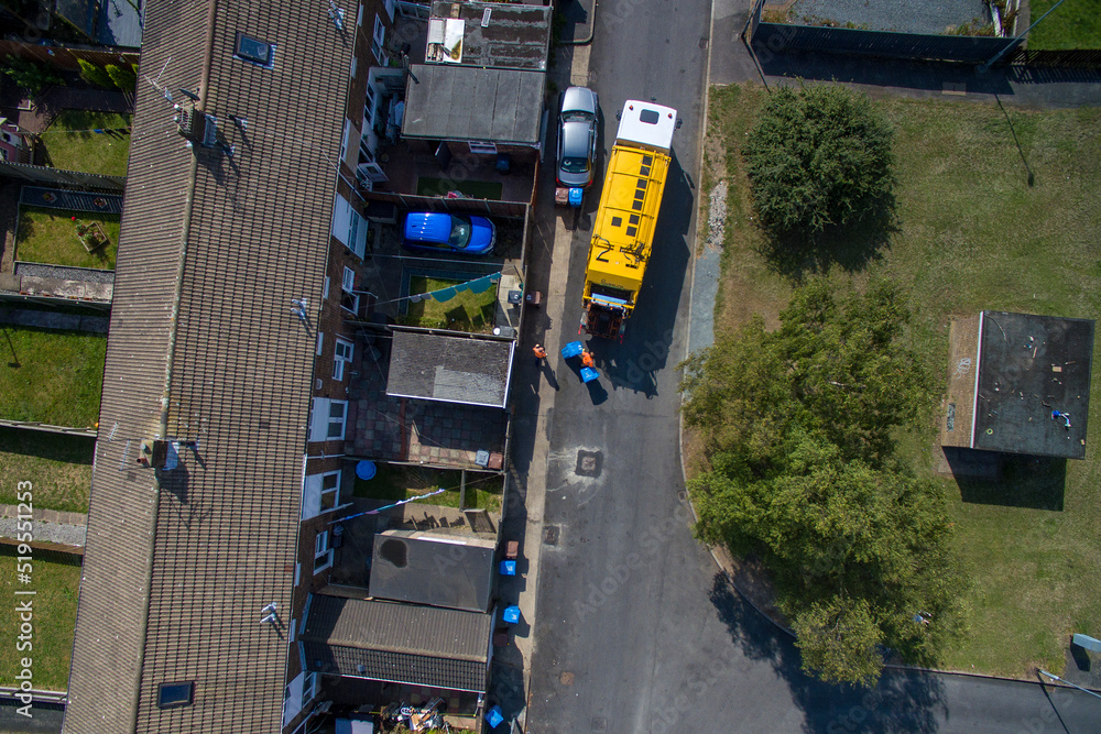 aerial view of refuse collecting lorry collecting domestic rubbish from ...