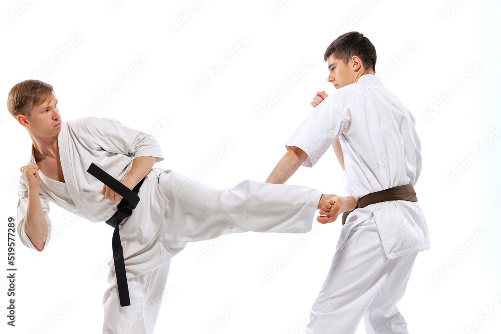 Two athletes, karate-do fighters in doboks practicing karate isolated ...