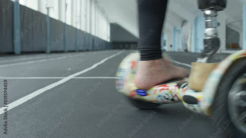 Close up shot of legs of barefoot man with prosthetic foot spinning on ...