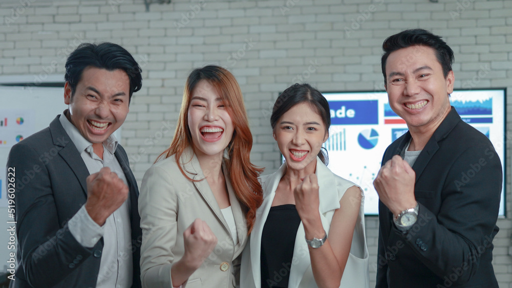 Group of happy young Asian employees raising their hands to celebrate business success. Stock ...