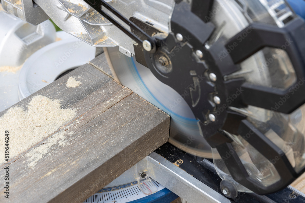Miter circular saw photographed in the process of work. Tool for ...