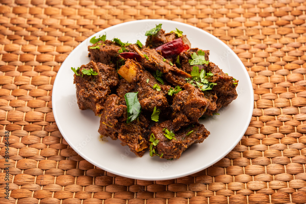 Sukha mutton or chicken, dry spicy Murgh or goat meat served in a plate ...