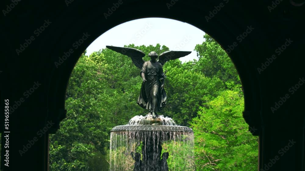The Bethesda Fountain continuously drips water to basin, among green ...