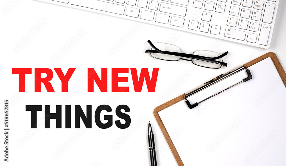 TRY NEW THINGS text written on the white background with keyboard ...