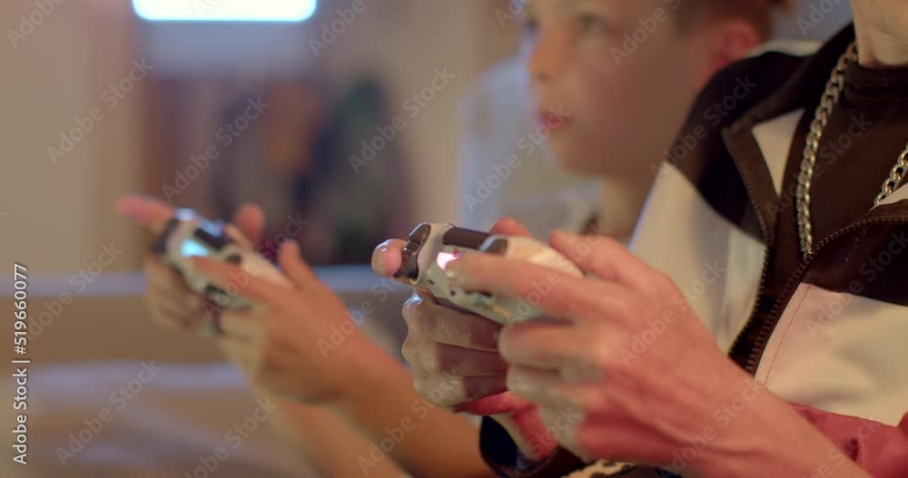 Video game controller in the hands of a man, the boy points with his ...