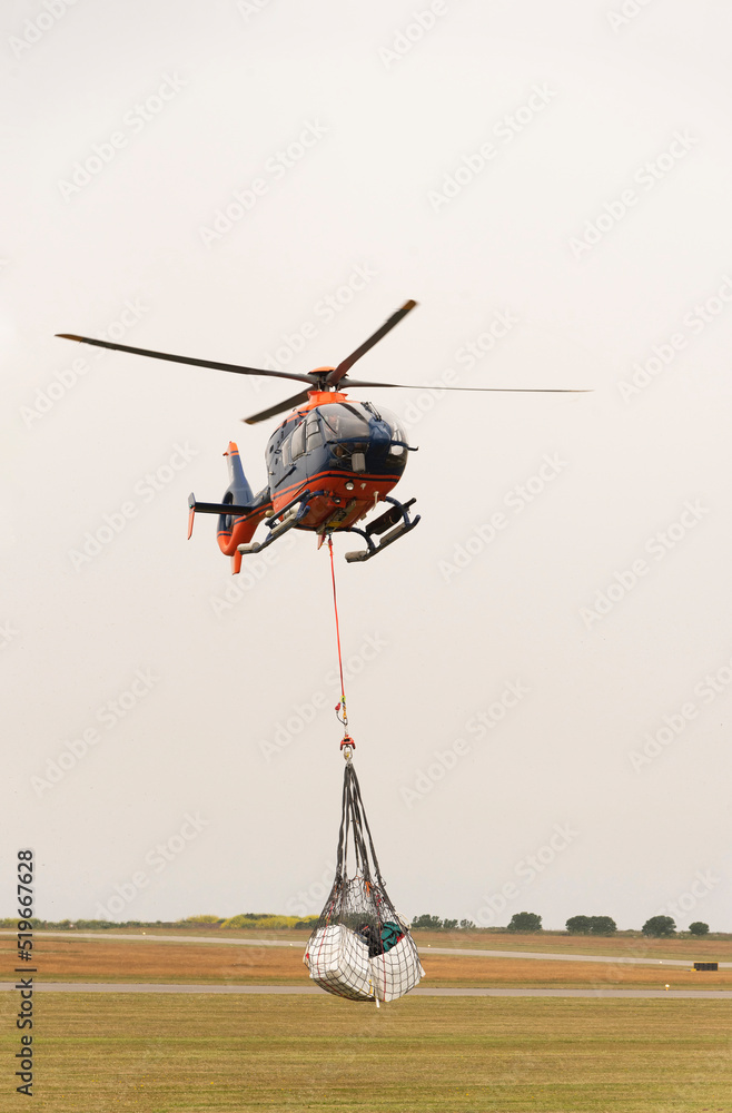 Cornwall, England, UK. 2022. Airlift helicopter with carrying strap and ...