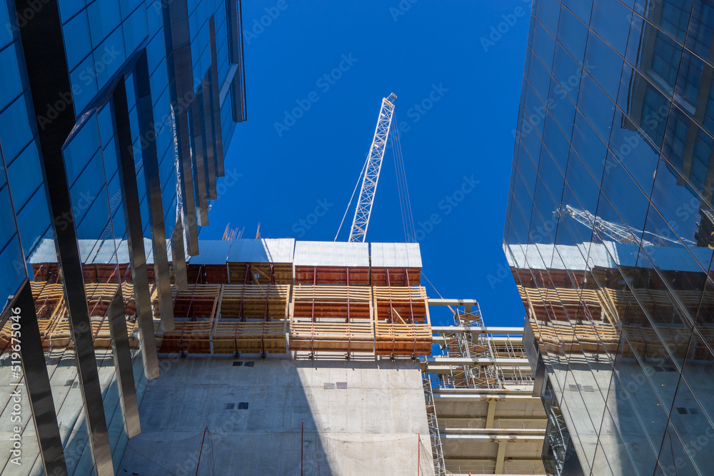 Construction of a high-rise building. Construction crane, scaffolding ...