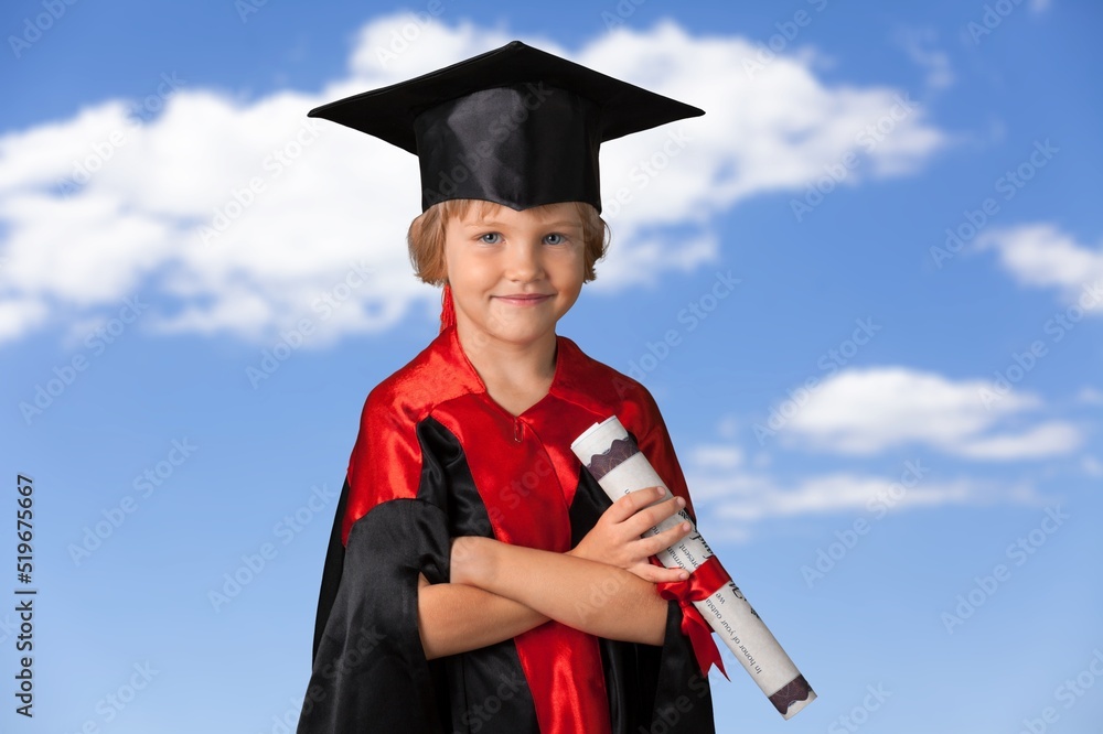Cute kid wearing graduation cap and ceremony robe with certificate ...